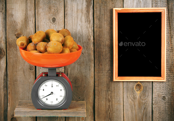 Kiwi on scales Stock Photo by Artem_ka | PhotoDune