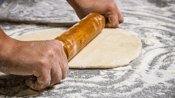 Preparation of the dough . The dough rolling the women's hands. Stock ...