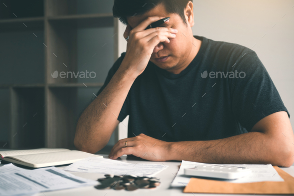 men are stressed about financial problems, with invoices and ...