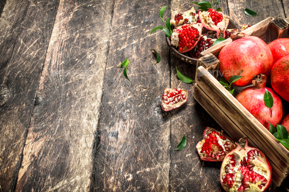 Fresh pomegranates in an old box. Stock Photo by Artem_ka | PhotoDune