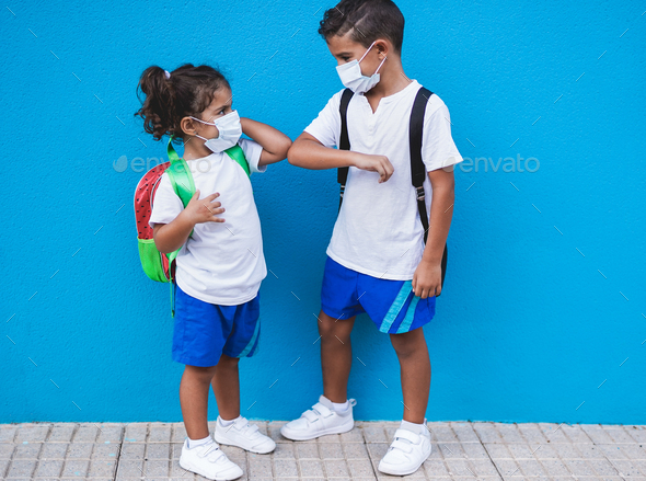 Cheerful children meet and greet each other with elbow Stock Photo by ...