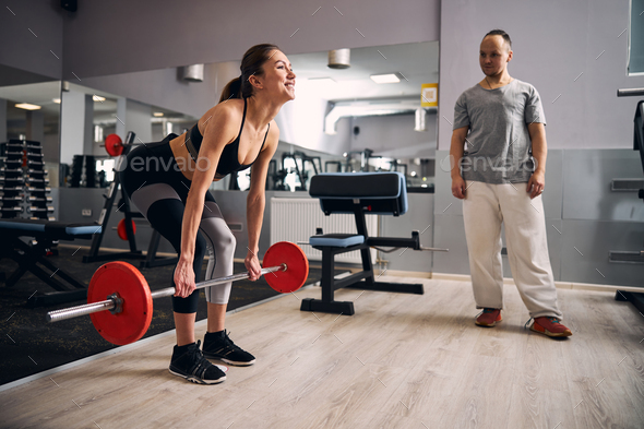 Positive delighted female person doing physical training Stock Photo by ...