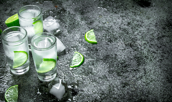Vodka with pieces of lime and ice cubes. Stock Photo by Artem_ka ...