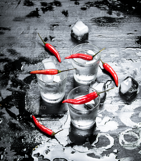 Vodka shots with hot chili peppers and ice. Stock Photo by Artem_ka