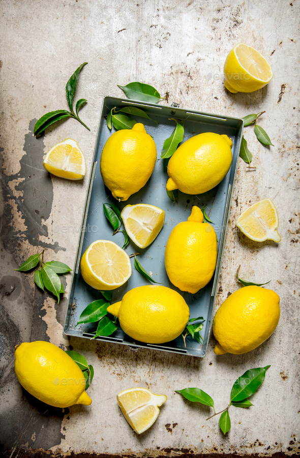 Lemons in a metal box with leaves. Stock Photo by Artem_ka | PhotoDune