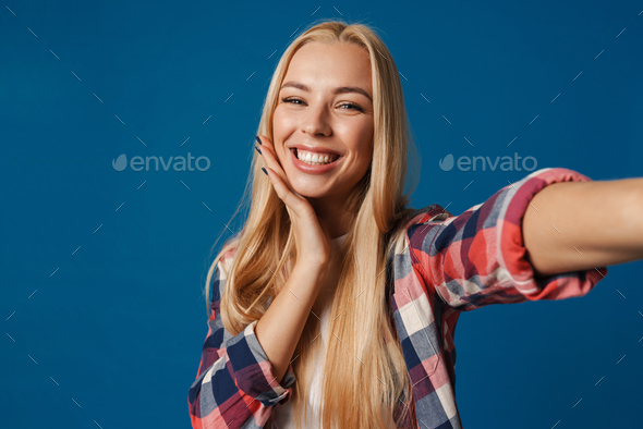 Happy beautiful blonde girl smiling while taking selfie photo Stock ...