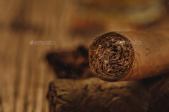 Pile of new cigars close up on wooden table Stock Photo by FabrikaPhoto
