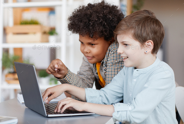 Two Boys using Computer in Class Stock Photo by seventyfourimages ...