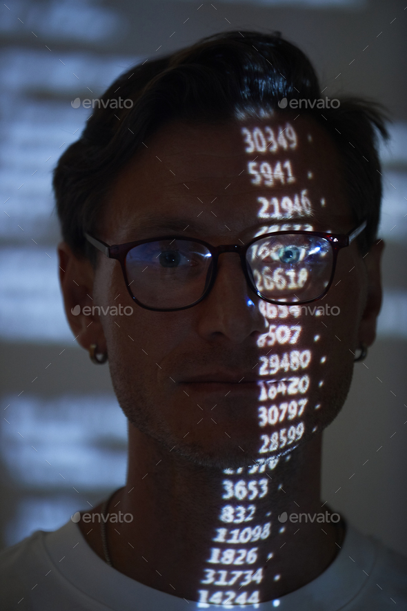 Computer hacker examining numbers Stock Photo by seventyfourimages