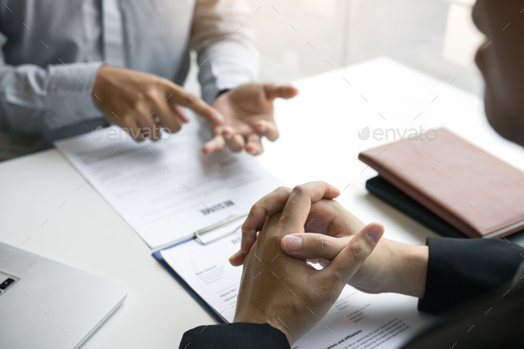 Male employee is explaining to the manager while being interviewed in ...