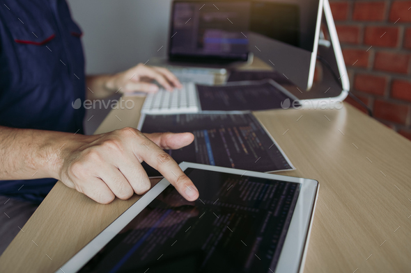 Software developer is pointing to the paper working and analyzing ...