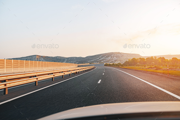 Empty highway at dawn, view from driver's perspective Stock Photo by ...