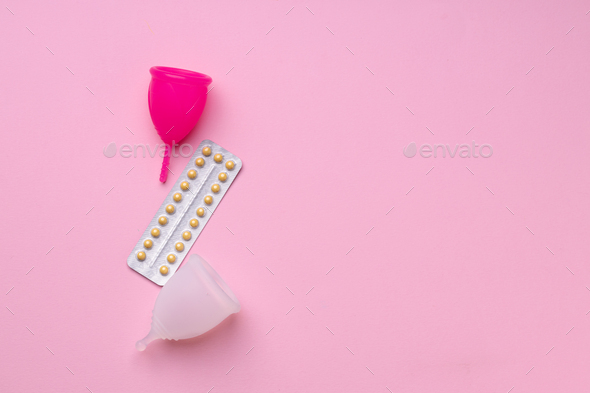 Menstrual cup and oral contraceptive pills top view Stock Photo by ...