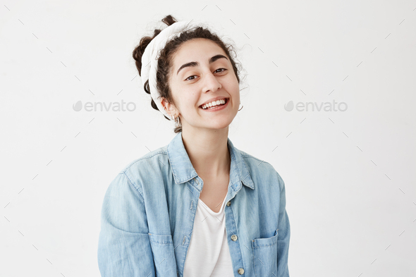 Dark-haired young female model wearing do-rag and denim shirt, looks ...