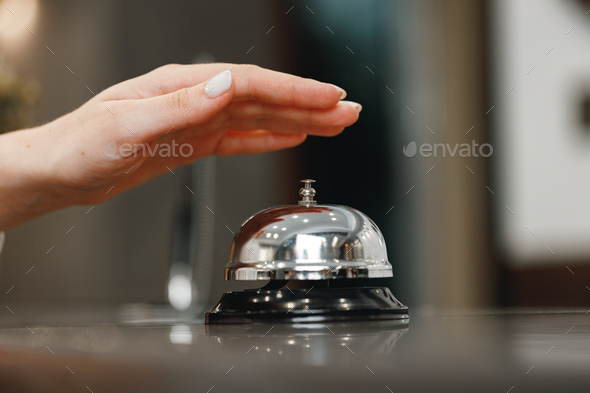 Hotel service bell on front desk counter Stock Photo by FabrikaPhoto