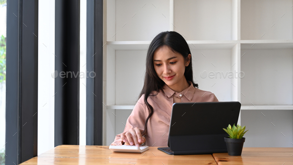 Smiling woman accountant working with computer table and using ...