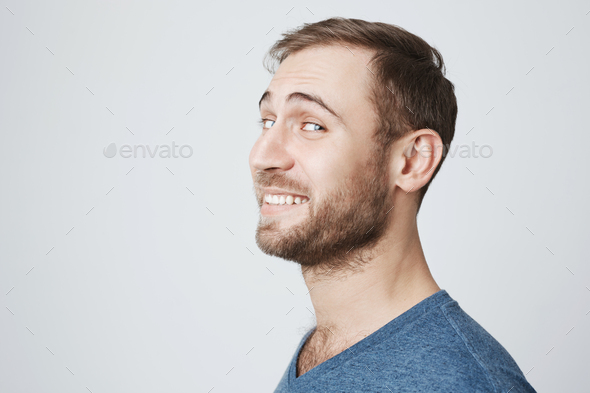 Profile of smiling good-looking attractive man in blue t-shirt with ...