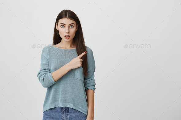 Studio portrait of attractive caucasian student, showing surprise and ...