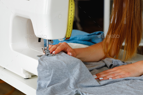 Process of stitching on sewing machine close up view Stock Photo by ...