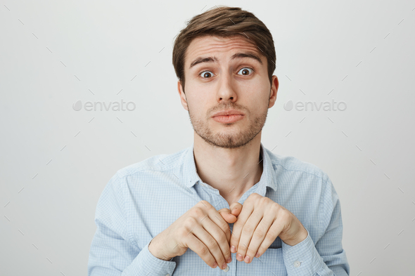 Portrait of cute attractive european male model making innocent and ...