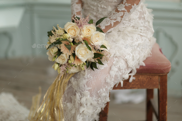Bride in a luxury bridal dress sitting on a vintage chair Stock Photo ...