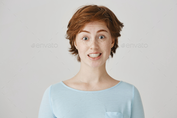 Studio portrait of attractive caucasian female with red hair and ...