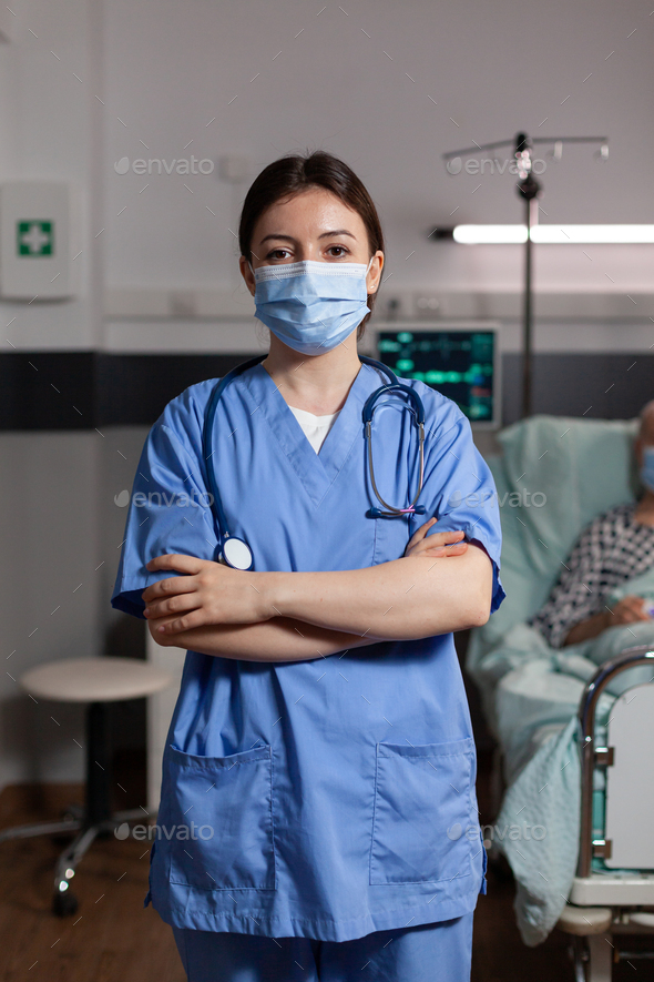 Portrait of medical nurse with chirurgical mask Stock Photo by DC_Studio
