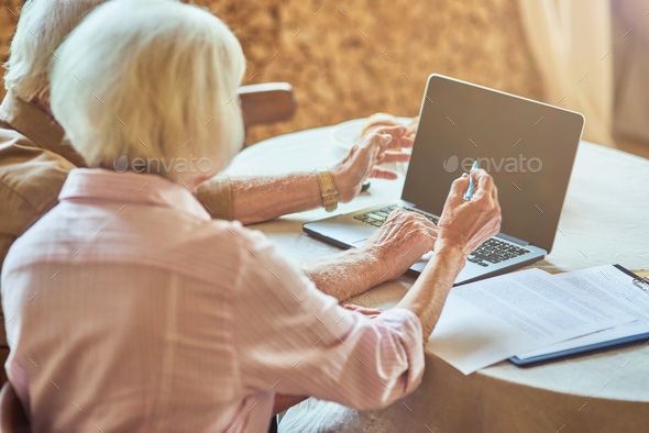 Elderly husband and wife using computer at home Stock Photo by friends ...