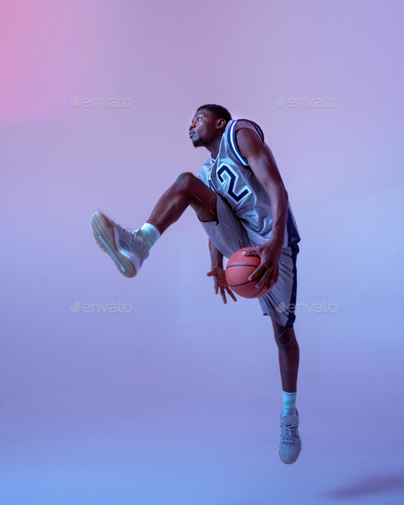 Basketball player moving with ball in studio Stock Photo by NomadSoul1