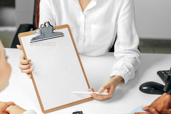 Female hand signing sheet of paper on clipboard Stock Photo by FabrikaPhoto