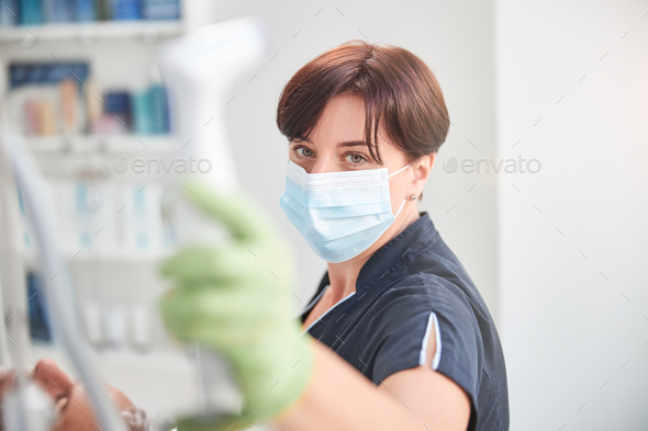 Competent spa worker posing with a skincare treatment apparatus Stock ...