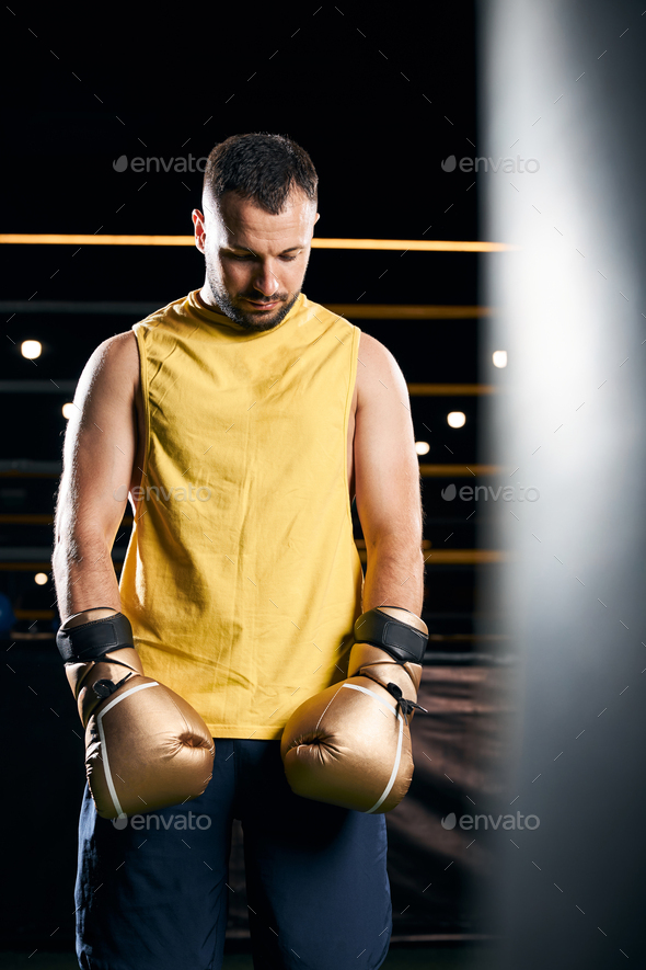 Sad boxing champion standing with his head down Stock Photo by Iakobchuk