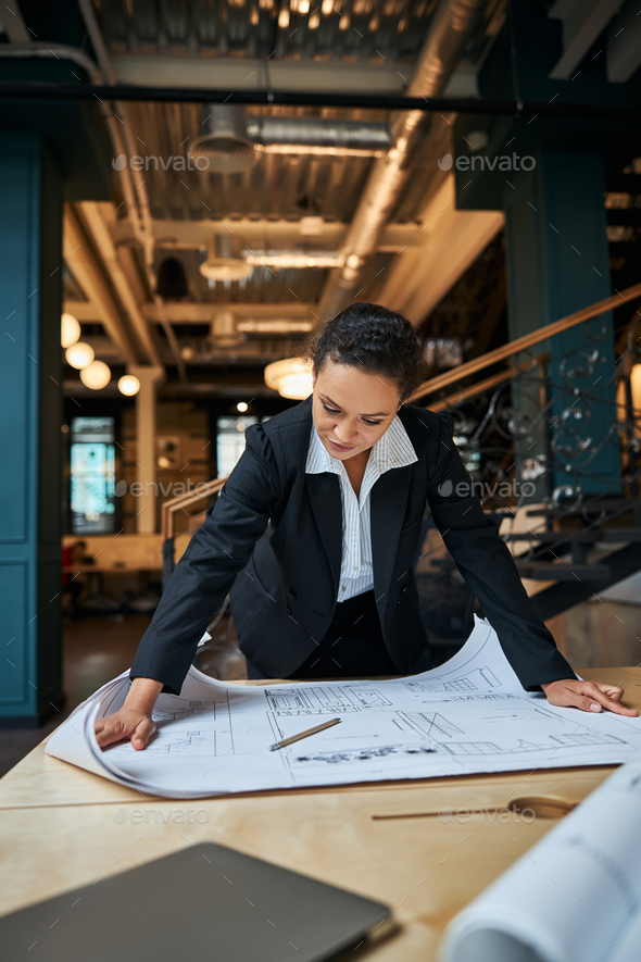 Attentive young female staring at her drawing Stock Photo by Iakobchuk