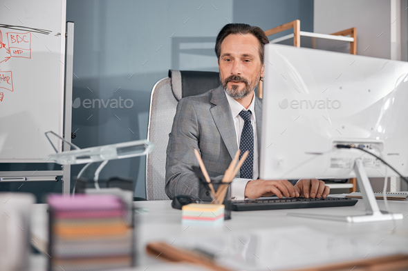 Male worker using modern computer in office Stock Photo by Iakobchuk