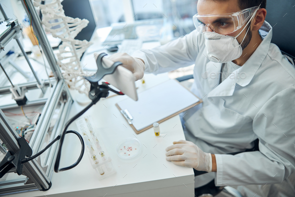 Scientist enabling live streaming on his smartphone Stock Photo by ...