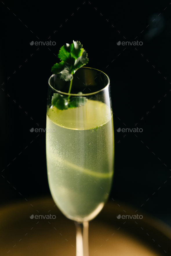 Bartender make drinks. Transparent cocktails in glass on dark ...