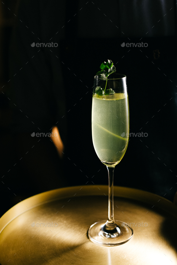 Bartender make drinks. Transparent cocktails in glass on dark ...