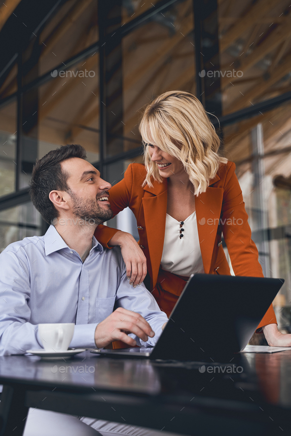 Two office workers smiling at each other Stock Photo by Iakobchuk ...