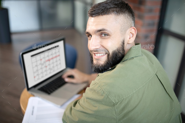 Top view of handsome man feeling motivated while working Stock Photo by ...
