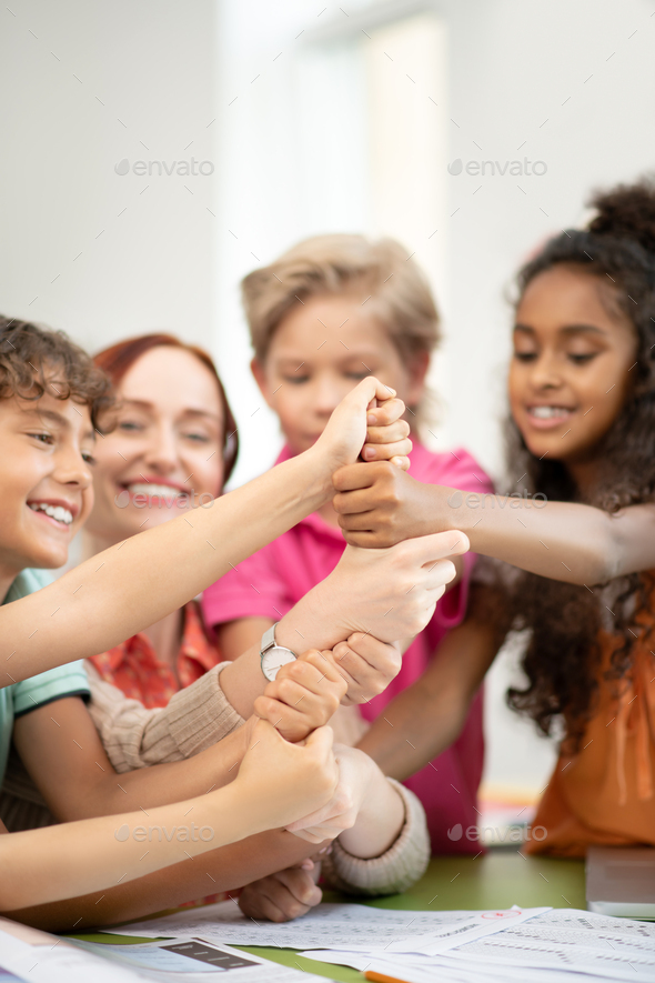 Children and teacher greeting each other in the morning Stock Photo by ...