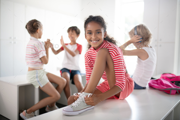Cheerful dark-skinned girl feeling happy after PE class Stock Photo by ...