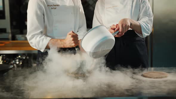 Professional kitchen: liquid nitrogen is added during the cooking of a ...