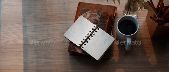Horizontal image of empty notebook, coffee cup and plant on wooden ...