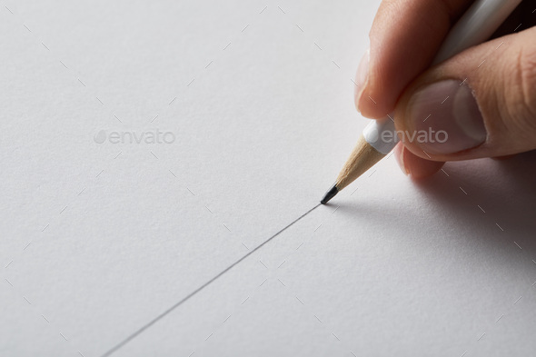 cropped view of man drawing line on paper with pencil Stock Photo by ...