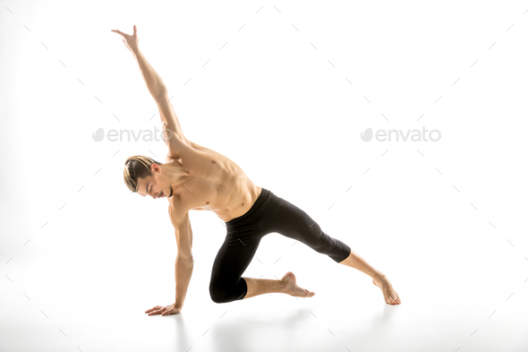 Young handsome shirtless man performing dance movemen isolated on white ...