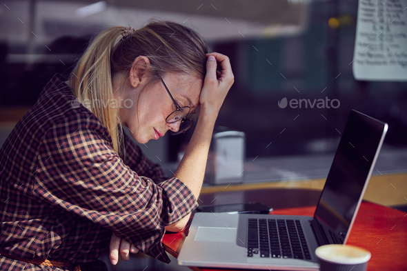 Brooding woman in glasses during working a side view Stock Photo by ...