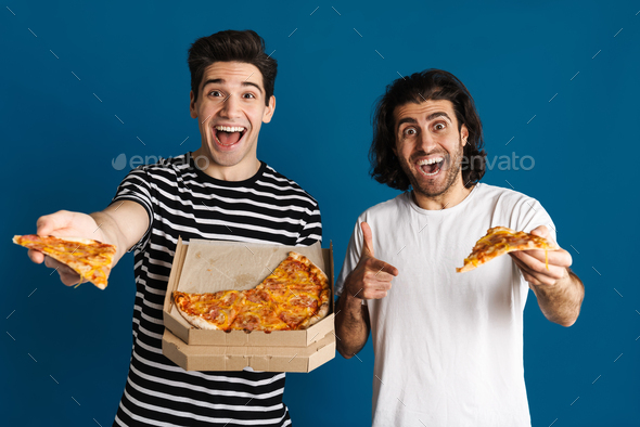 Excited two men screaming and posing with pizza Stock Photo by vadymvdrobot