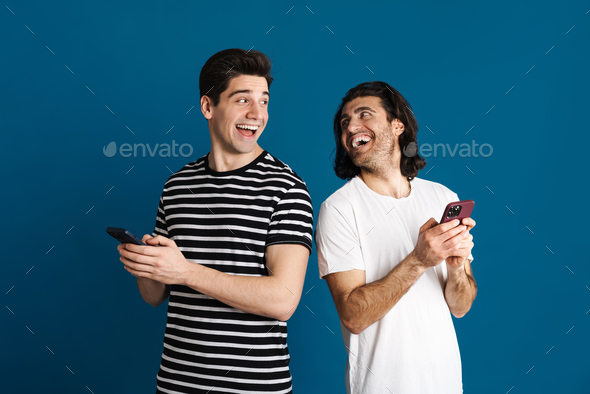 White happy two men laughing while using mobile phone Stock Photo by ...