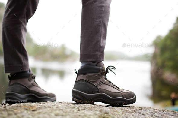 side portrait hiker standing in boots on rock Stock Photo by ...