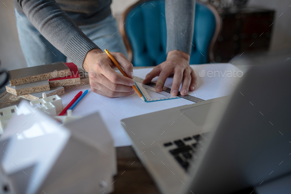 Man using ruler and pencil while making sketches Stock Photo by Zinkevych_D